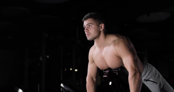 Athletic Young Man Training in the Gym with a Bodybar Lying Down Doing ...