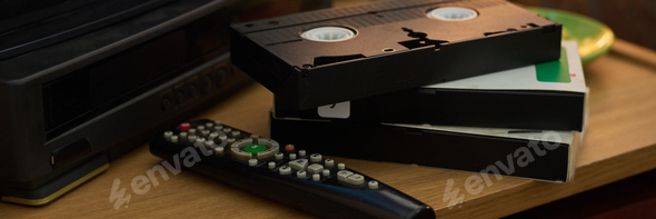 Stack of Vintage VHS Tapes and Remote Control Stock Photo by Pressmaster
