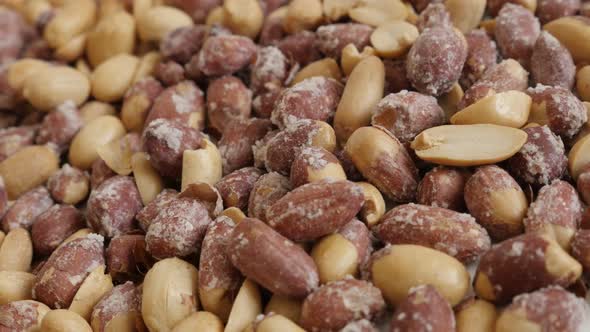 Salted groundnuts on pile close-up 4K 2160p 30fps UltraHD panning ...