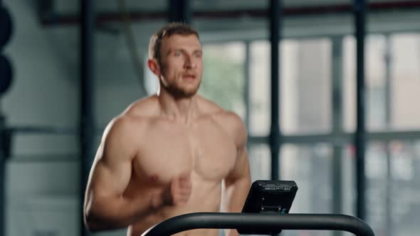Male athlete athlete is doing cardio training on a treadmill ...