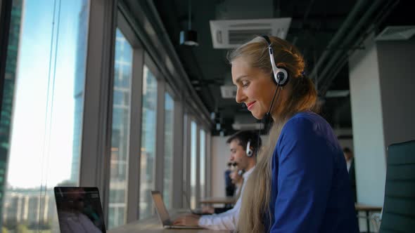 Customer Service Talking To a Customer in Busy Call Center, Stock Footage