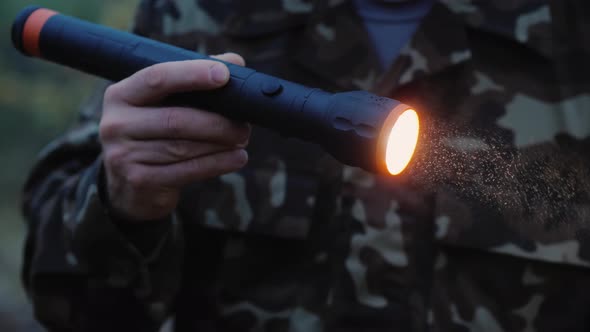 A Hand with a Flashlight Illuminates the Path in the Forest, Drops of ...