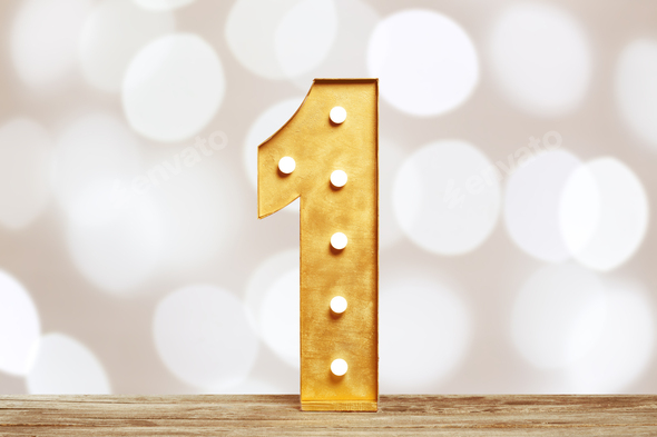 Big plastic numbers with shining light bulbs Stock Photo by FabrikaPhoto