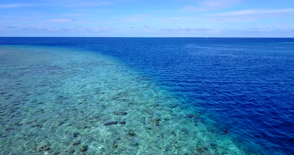 Deep blue sea touches turquoise lagoon with calm clear water over rocky ...