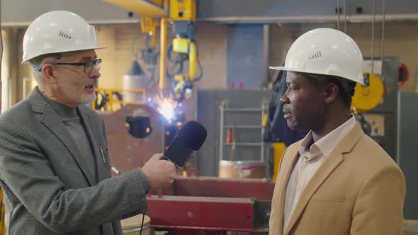 TV Reporter Interviewing African American Factory Engineer, Stock Footage