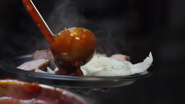 Adding Sauce to Street Food Plate with Grilled Meat and Chopped Onions ...
