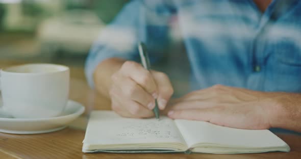 Man Writing in Coffee Shop, Stock Footage | VideoHive