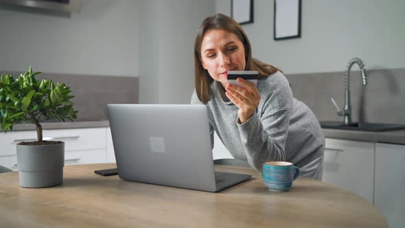 Woman Standing in Home Cozy Kitchen Leaning Over the Table and Makes an ...