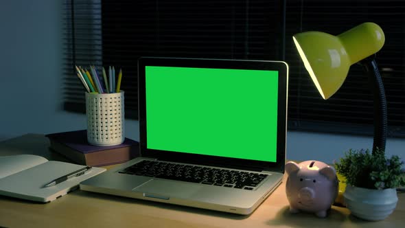 Chroma key green screen laptop computer set up for work on home office ...