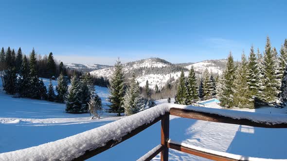 Timelapse snow is drowning on the railing. Shadows and clouds are ...