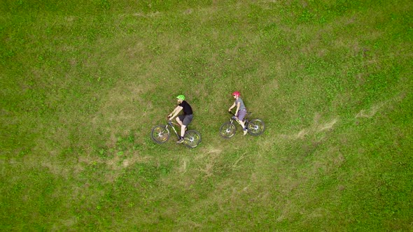 Aerial view of cyclists lying down on the grass with their bicycles in ...