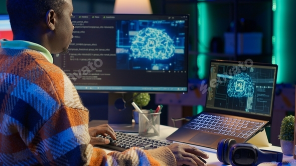 Black man programmer manages code and scripts in artificial intelligence Stock Photo by DC_Studio
