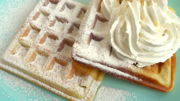 Preparation of waffles. Whipped cream is applied to the waffles., Stock ...