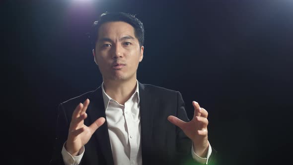 Close Up Of Asian Speaker Man In Business Suit Holding His Hands ...