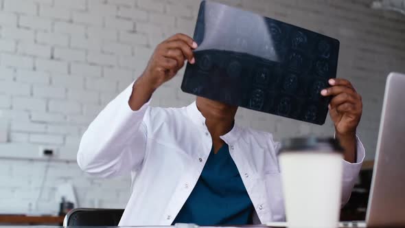 African American Black Man Doctor Looking at MRI Brain Scan Image While ...