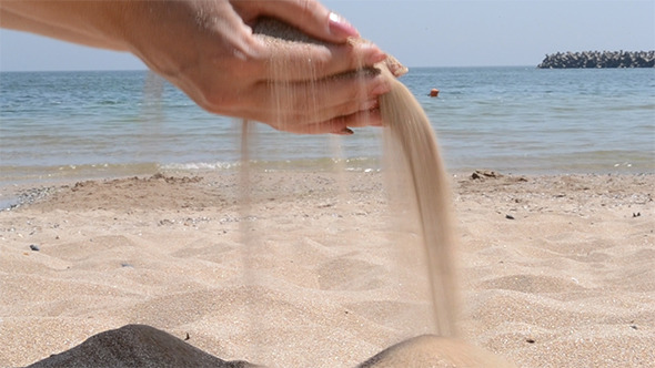 Woman Pouring Fine Sand Through Fingers, Stock Footage | VideoHive