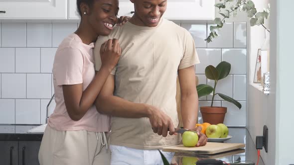 Cute Black Female Hugs Man From Back in Kitchen, Stock Footage | VideoHive