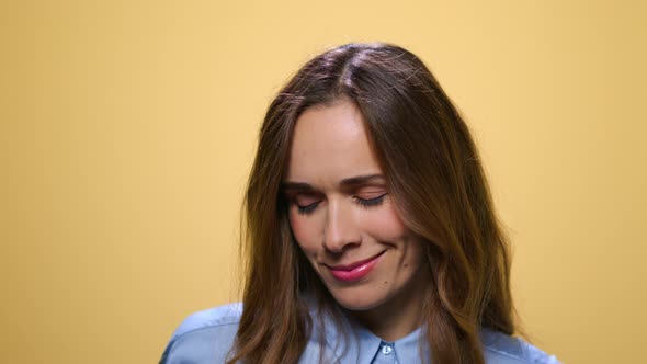 Beautiful Woman Flirting with Camera on Yellow Background. Woman Biting ...