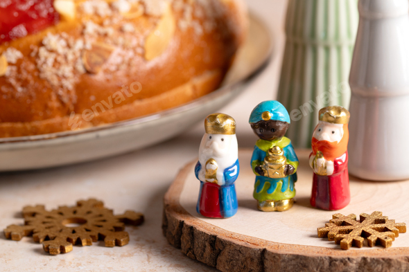 Card with traditional Three Kings Cake, three figurines of the kings in ...