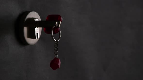 4K - In the dark, a hand inserts the key into the lock, Stock Footage