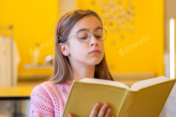 Serious teenage girl reading a book. Emotion concept. Stock Photo by ...
