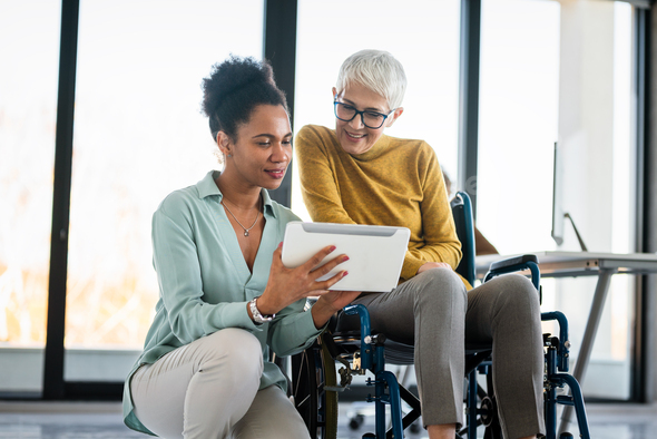 Multiracial coworkers analyzing charts and working together showing teamwork diversity and ...