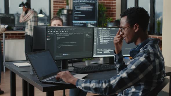 Portrait of Programer Fixing Glasses While Typing on Laptop Smiling ...