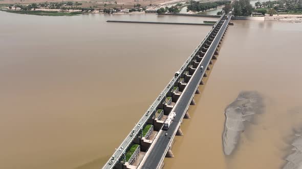 An aerial view of a village river bridge in day time on rural landscape ...