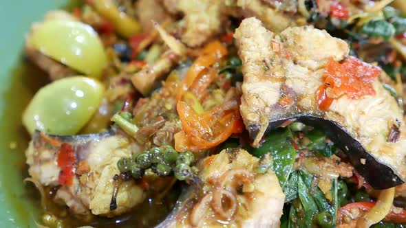 Close Up Footage of Thai Hot and Spicy Stir Fried Cat Fish and Herbs ...
