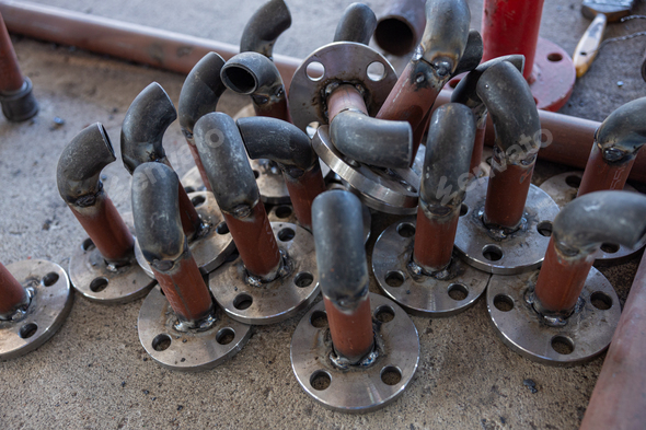 Welded Pipe Elbows with Flanges on Workbench Stock Photo by Fender_SRV