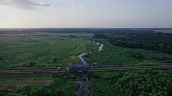 Railway Bridge in Countryside Passing Above Small River, Stock Footage
