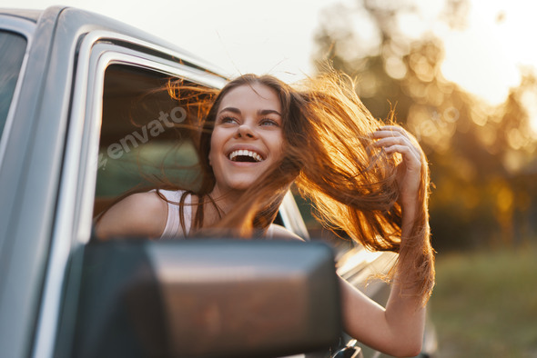 Young woman enjoying carefree moments with flowing hair in the open ...