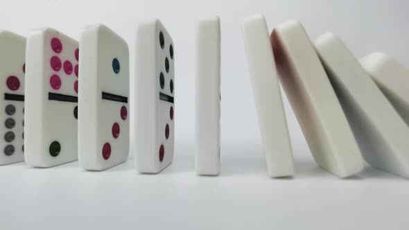 Dominoes Falling Over Against White, Stock Footage | VideoHive