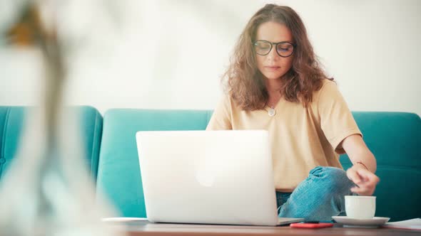 A Young Woman Remote Employee Working From Home with a Laptop, Stock ...
