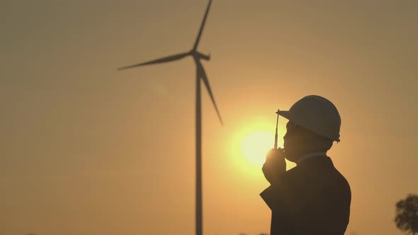 Engineers utilize a walkie-talkie for long-distance communication in ...