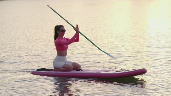 Fitness Woman Practising in Paddle Boarding During Sunset, Stock Footage