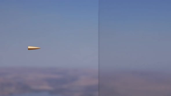 Slow-motion shot of a spinning bullet shattering a piece of glass ...