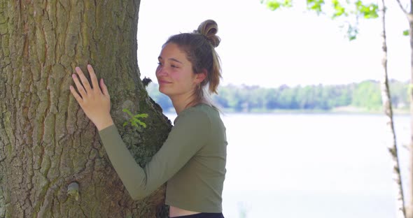 Contented Young Woman Hugging a Large Tree with a Blissful Expression ...