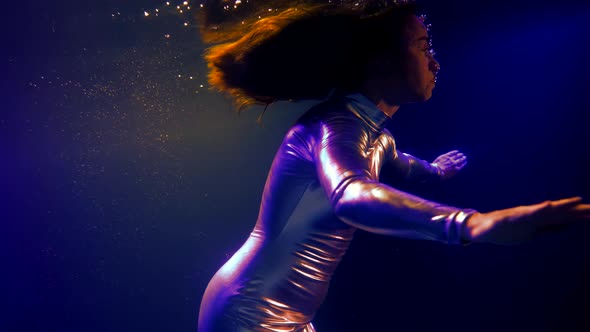 Adult Woman in Shiny Metallic Suit is Diving in Depth of Sea or Ocean ...