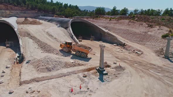 Aerial footage of large highway construction project with tunnels and ...