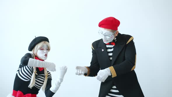 Male and Female Mimes Pulling Imaginary Rope Then Falling After Crazy ...
