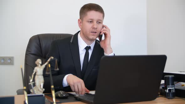 Successful Lawyer Taking a Phone Call at His Office. Speak Phone with ...