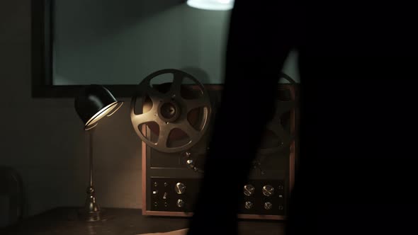 Interrogation room behind one-way mirror glass. Suspect sitting in a ...