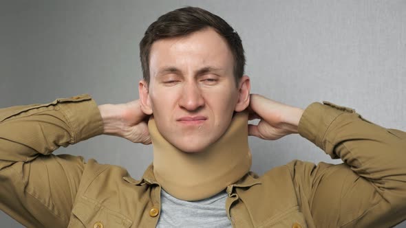 Man Puts on Bandage on Neck to Fix Cervical Vertebrae, Stock Footage