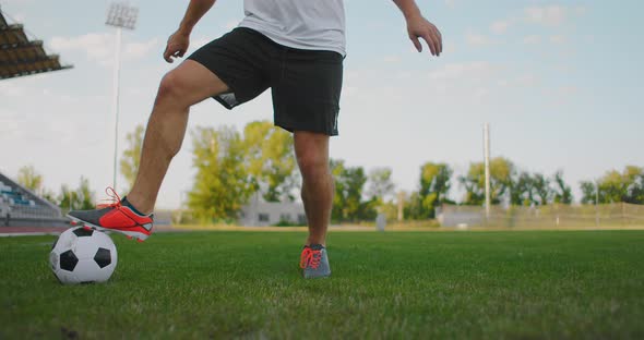 Close-up of a Male Soccer Player Running with a Soccer Ball on the ...