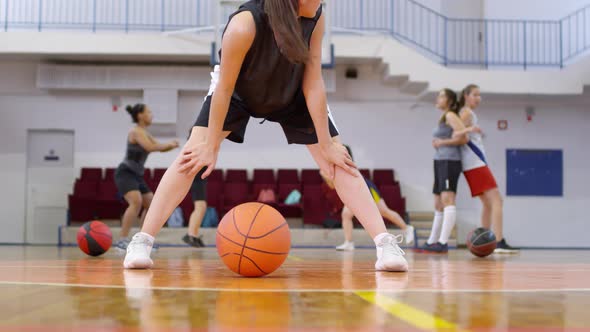 Young Female Basketball Player Stretching Legs on Court, Stock Footage