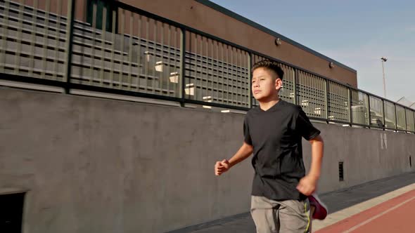 Boy Running On School Track, Stock Footage | VideoHive