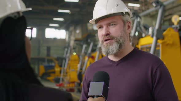 Senior Factory Engineer Giving Interview to TV Journalist, Stock Footage