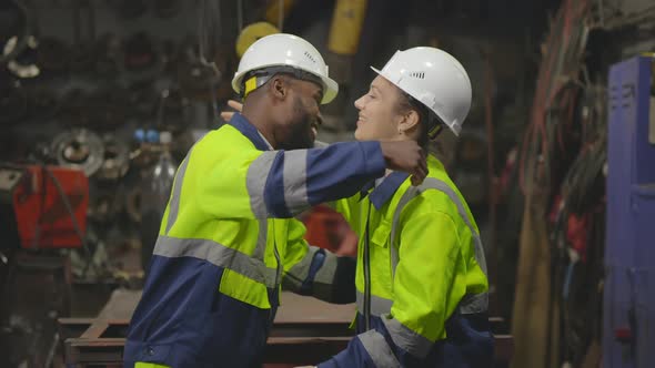 Diverse Engineers Hugging and Smiling in Factory Workshop, Stock Footage