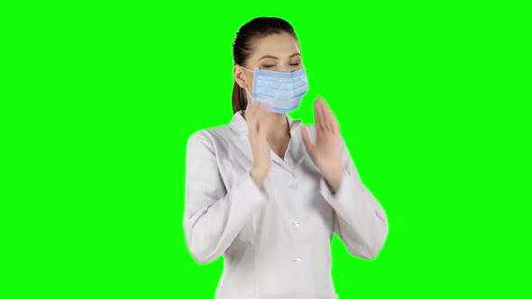 Young Attractive Woman Putting on Health Mask. Green Screen, Stock Footage